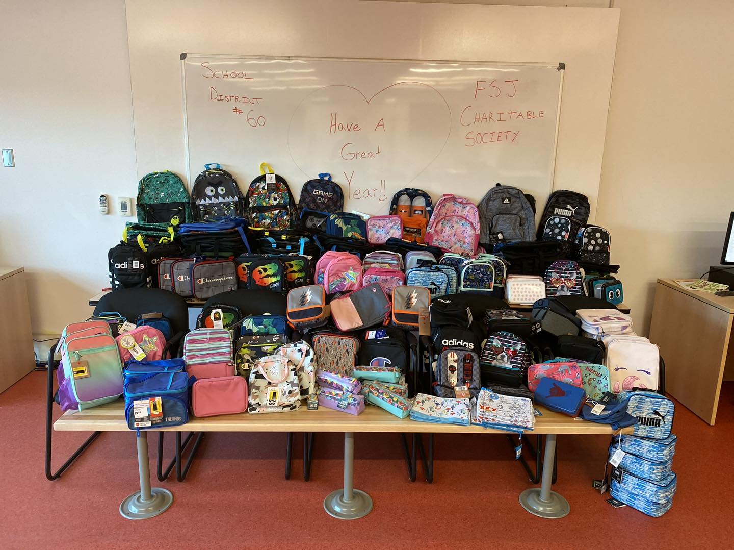 Fort St. John Firefighters Charity, Staples donate over 100 backpacks